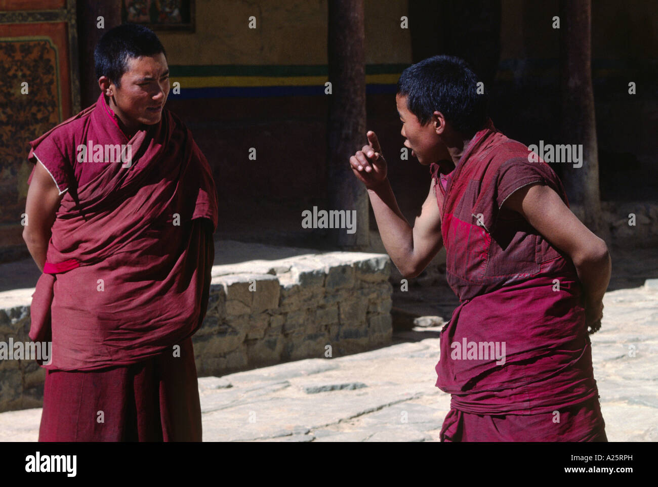Monks practicing ritualized TIBETAN BUDDHIST debate at TASHILUHUNPO ...