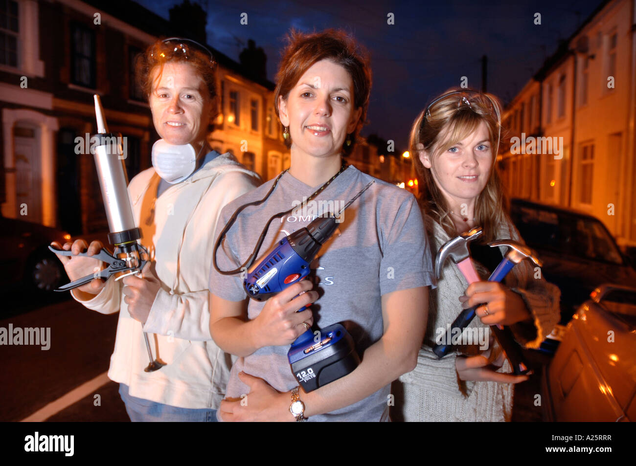 WOMEN WITH DIY TOOLS IN A TERRACED STREET UK Stock Photo - Alamy