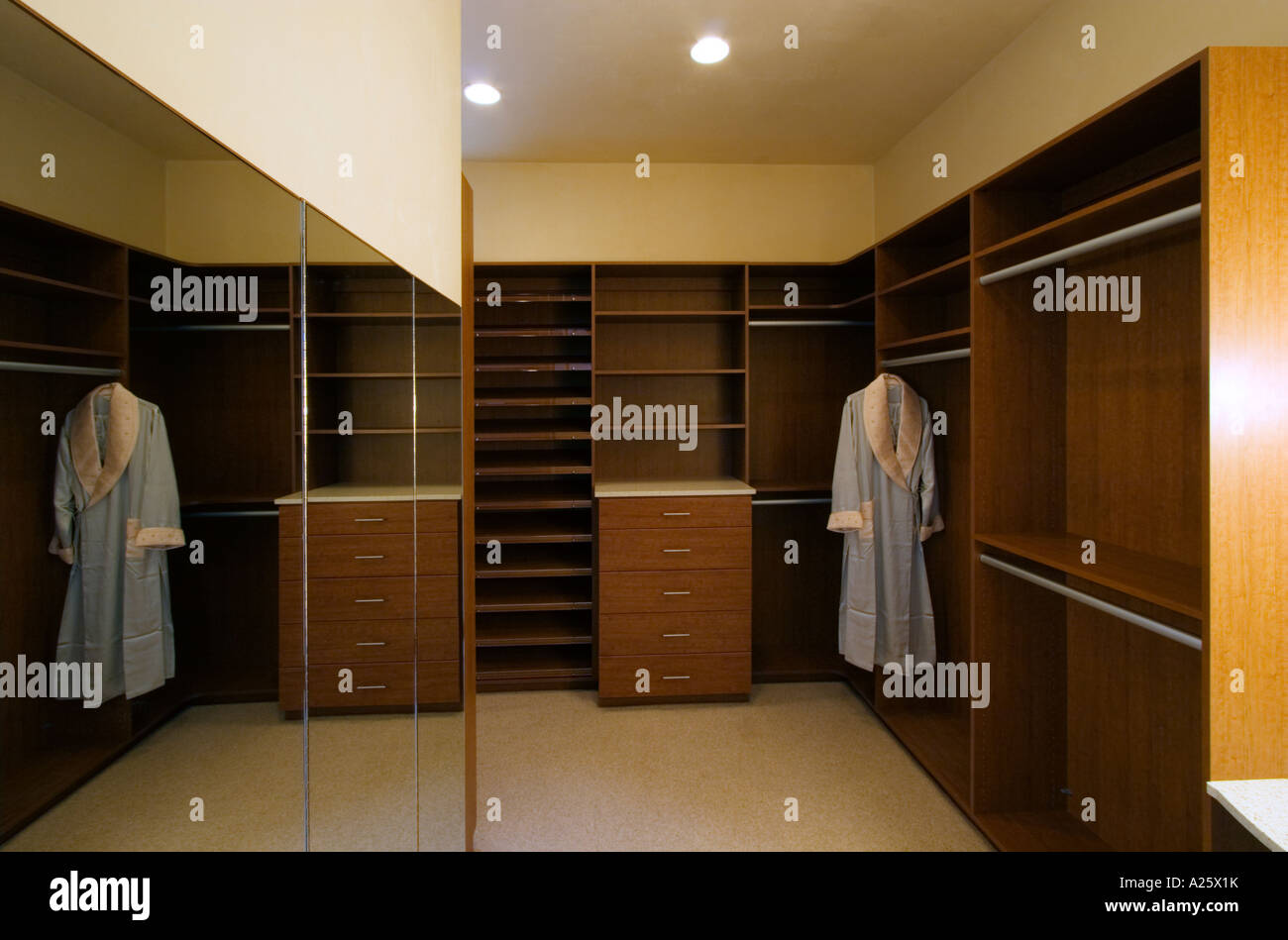 Large walk in DRESSING ROOM with build in wooden closets in a ...
