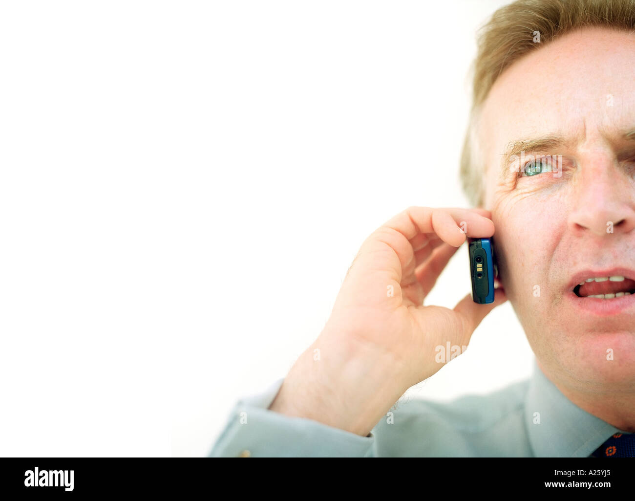 business man making mobile phone call, looking up into the middle ...