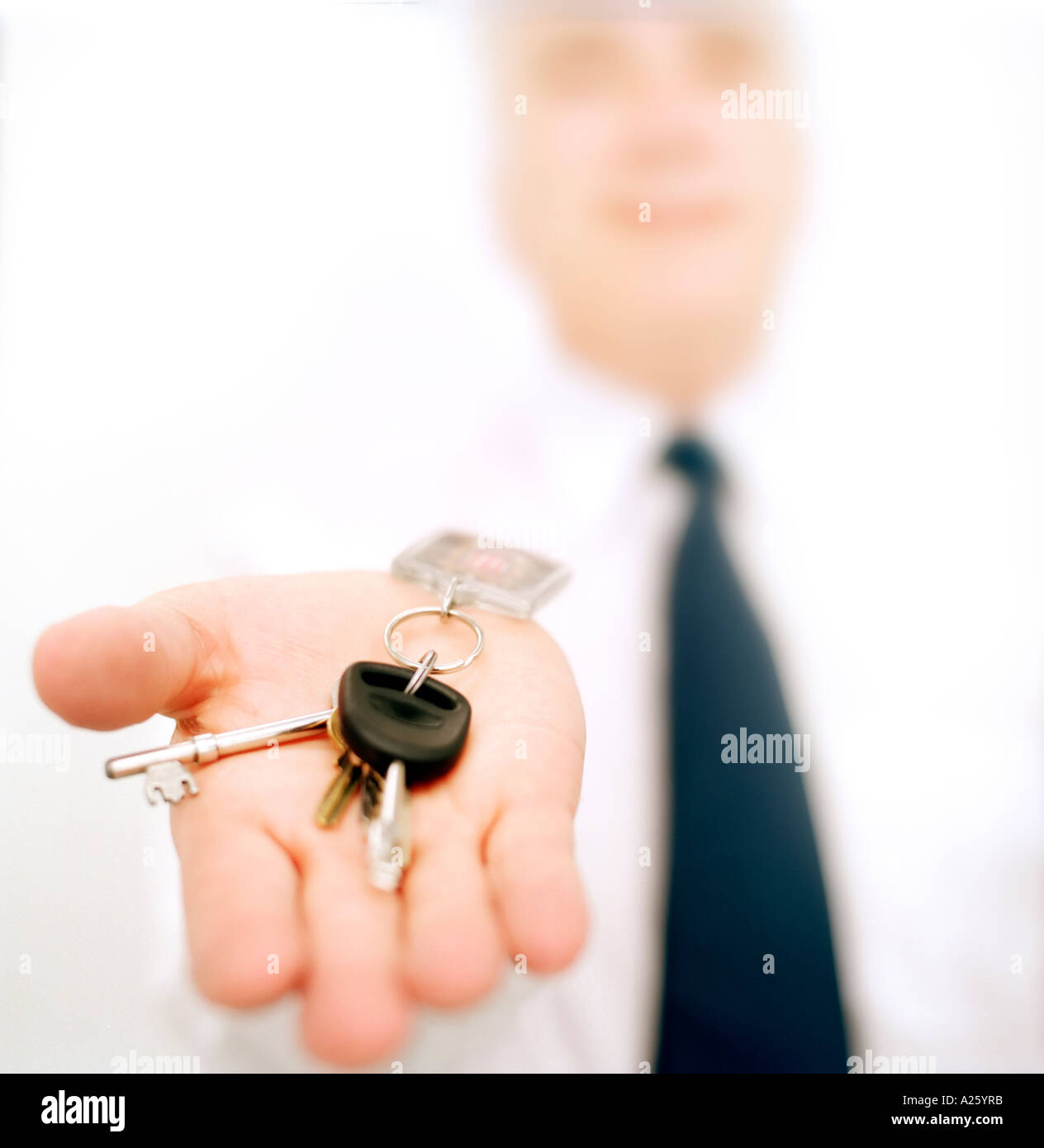 man offering keys for a car to the camera Stock Photo - Alamy