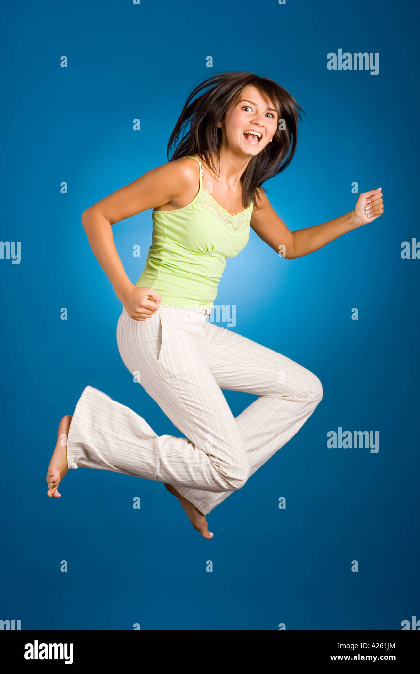 jumping happy woman on the blue background Stock Photo - Alamy