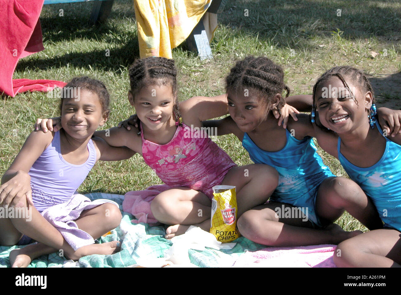 Children sitting at a picnic table having lunch together Stock Photo ...
