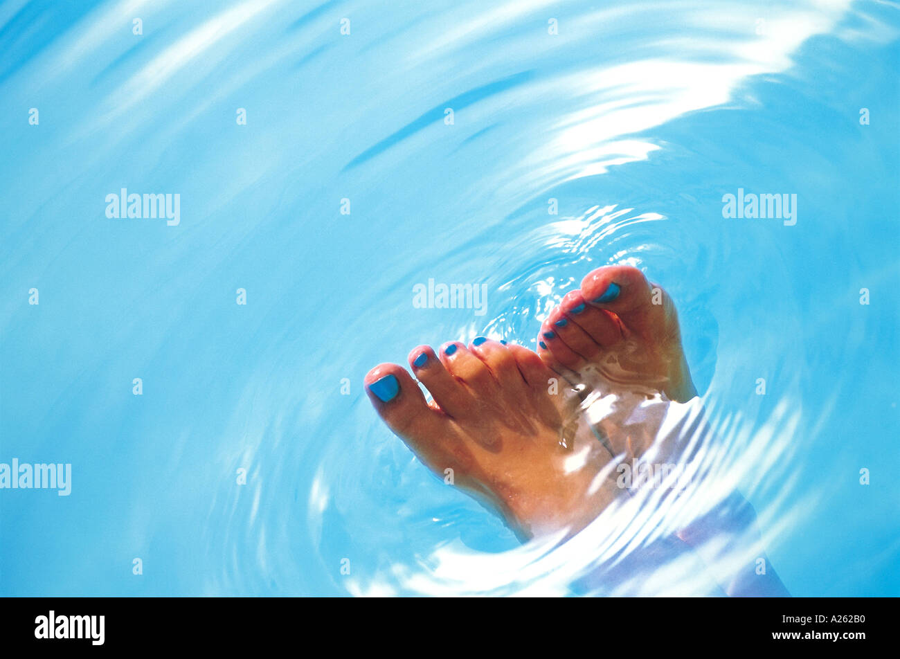 FEET WITH PAINTED TOES FLOATING IN SWIMMING POOL Stock Photo - Alamy