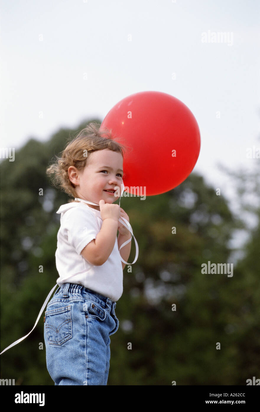 CHILD WITH RED BALLOON Stock Photo - Alamy