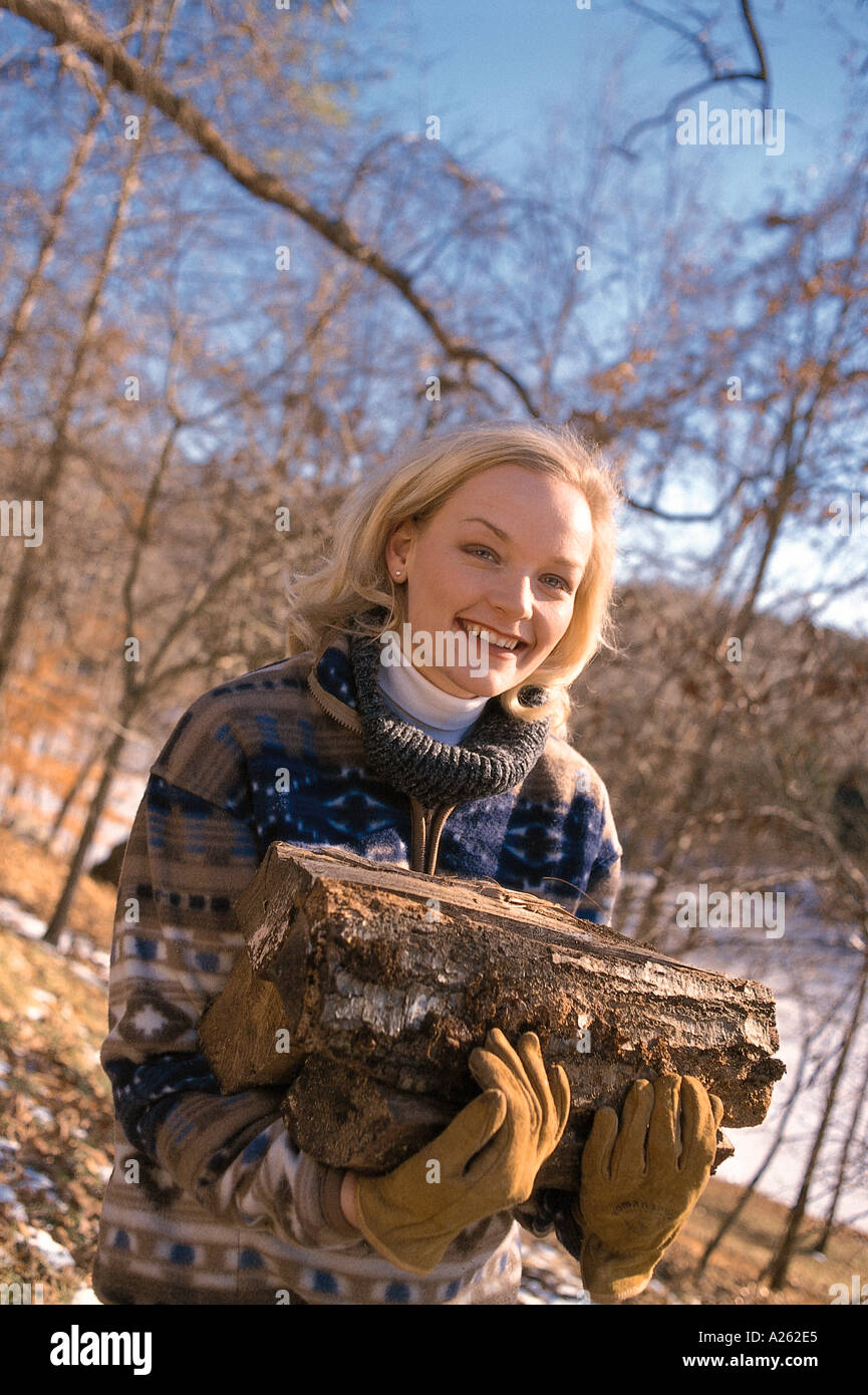 Woman carrying firewood logs hi-res stock photography and images - Alamy