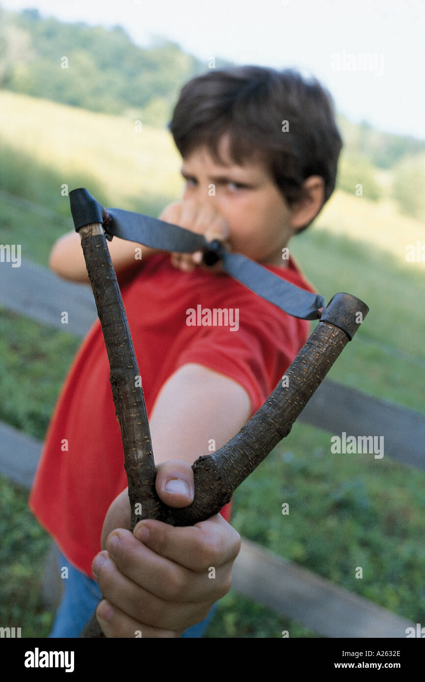 BOY AIMING CATAPULT Stock Photo - Alamy