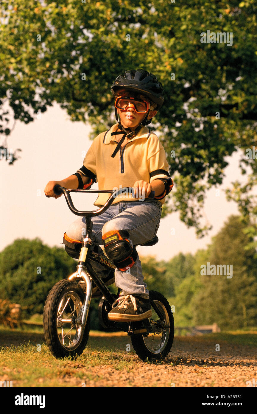 BOY RIDING BICYCLE WITH HELMET Stock Photo - Alamy