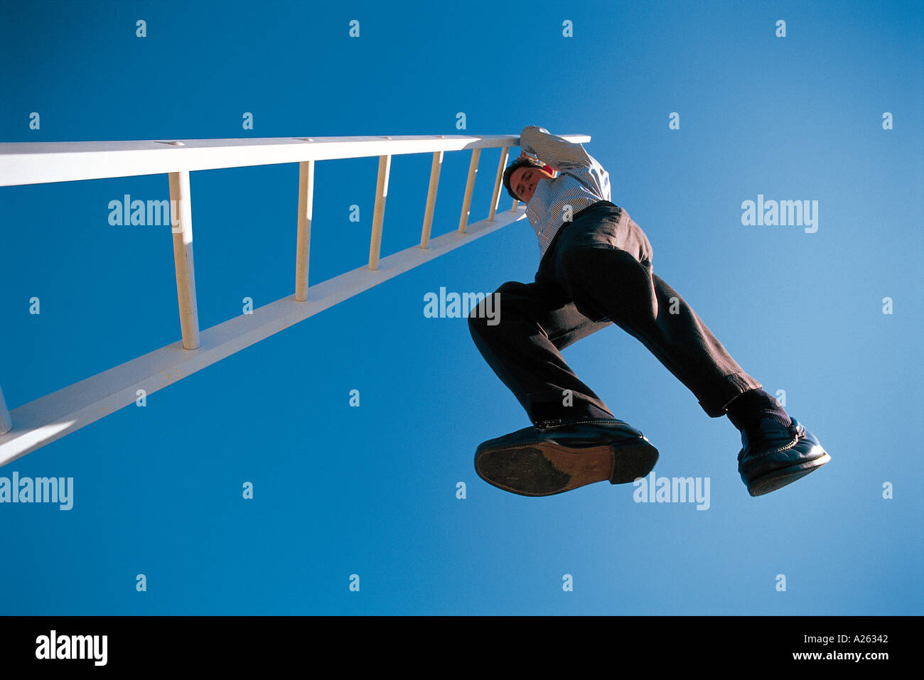 Business man hanging from ladder hi-res stock photography and images ...