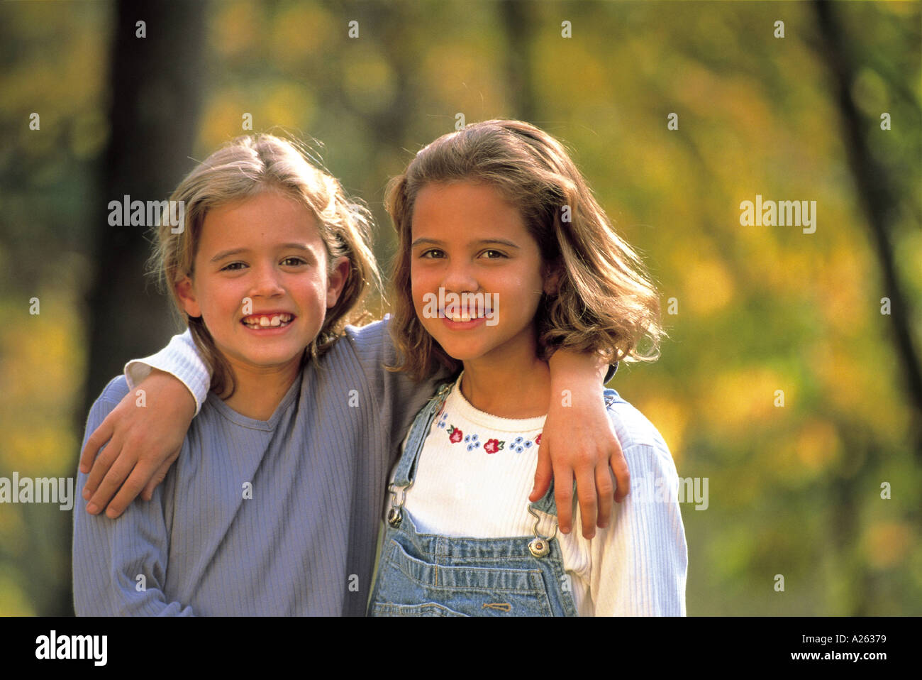 TWO YOUNG GIRLS WITH THEIR ARMS AROUND EACH OTHER Stock Photo - Alamy