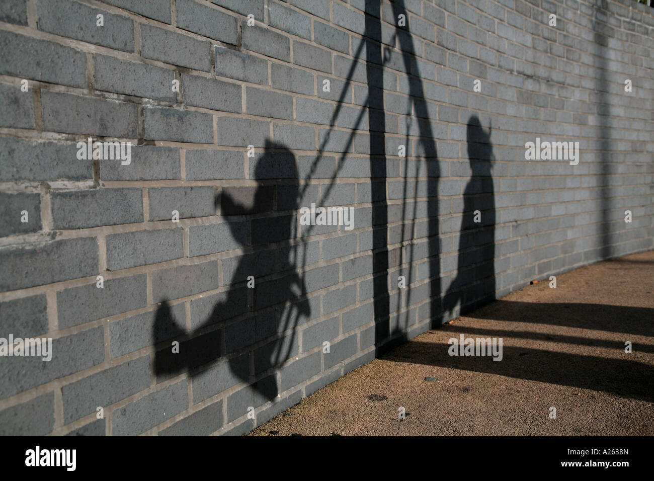 shadow of child on playground swing Stock Photo - Alamy