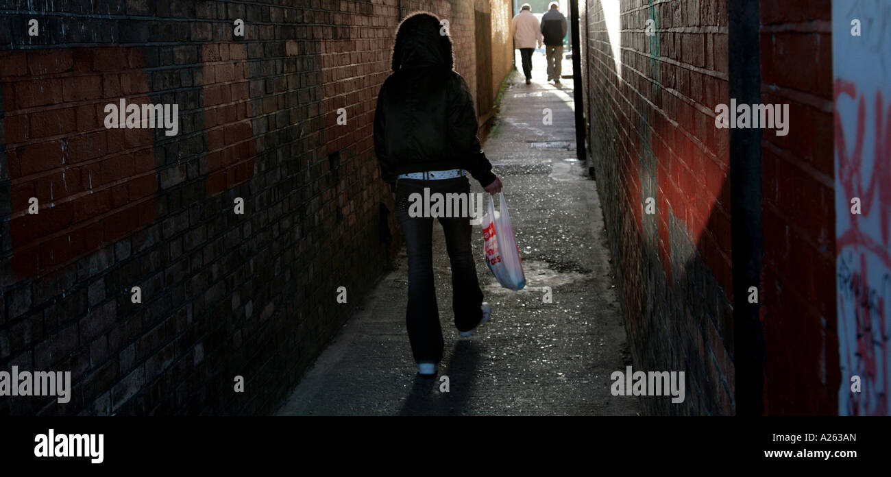 teenager walking down alleyway Stock Photo - Alamy