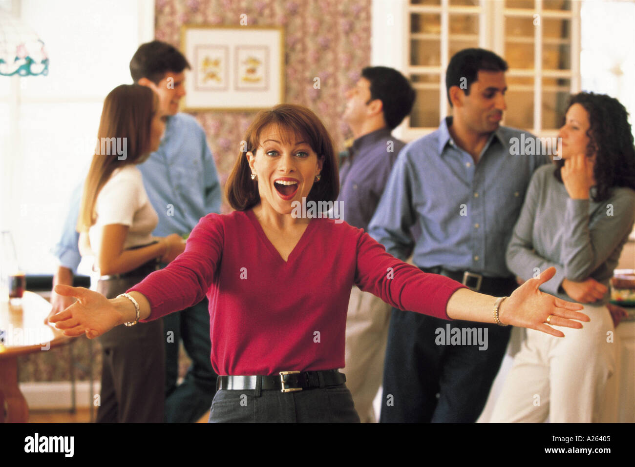 WOMAN WELCOMING GUESTS AT DINNER PARTY Stock Photo - Alamy