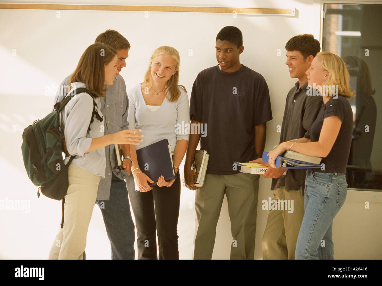 STUDENTS STANDING IN CORRIDOR HAVING CONVERSATION Stock Photo - Alamy