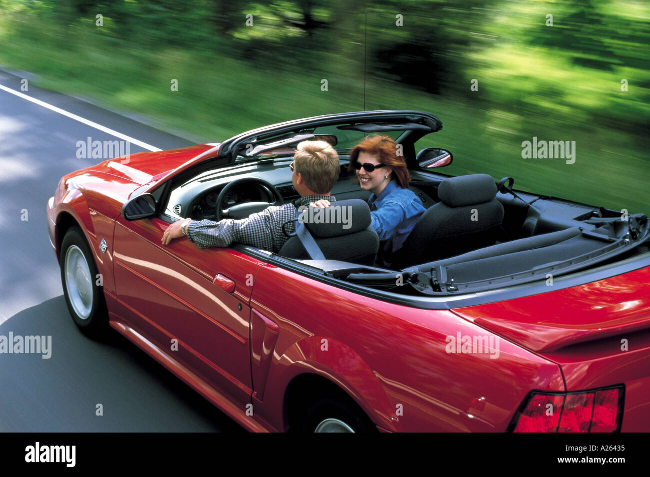 VIEW FROM BEHIND OF COUPLE DRIVING IN CONVERTIBLE Stock Photo - Alamy