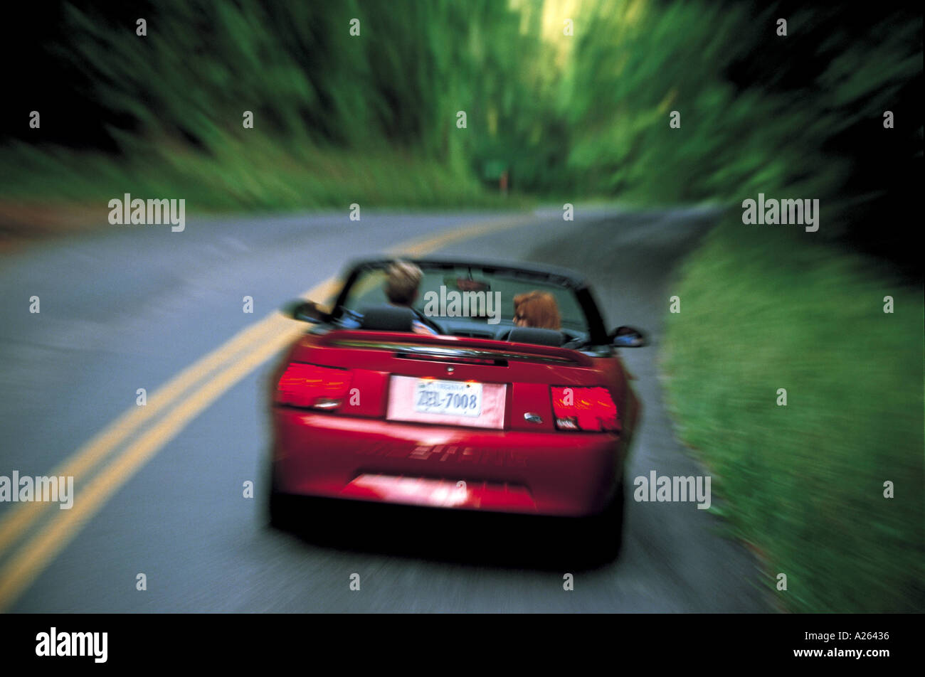 BLURRED VIEW OF COUPLE DRIVING IN OPEN TOP CAR Stock Photo - Alamy