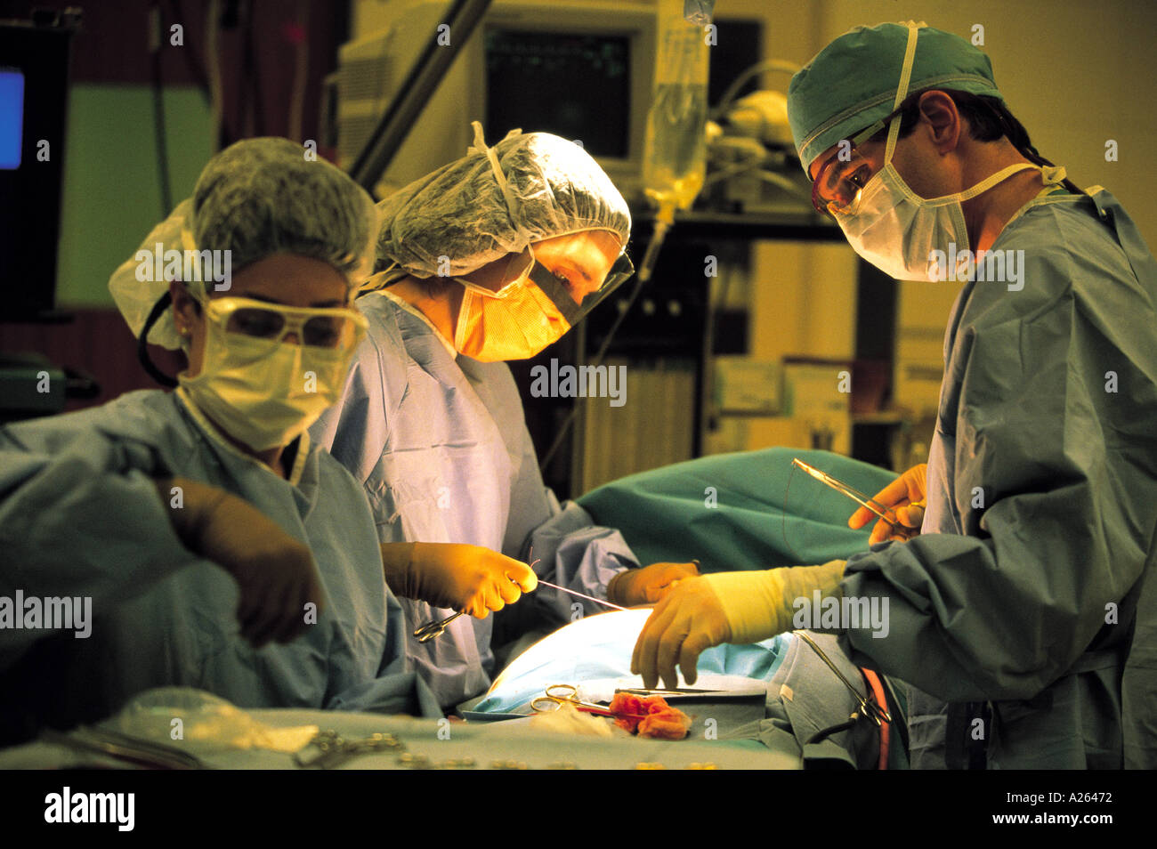 THREE SURGEONS PERFORMING A HERNIA OPERATION ON A CHILD Stock Photo - Alamy