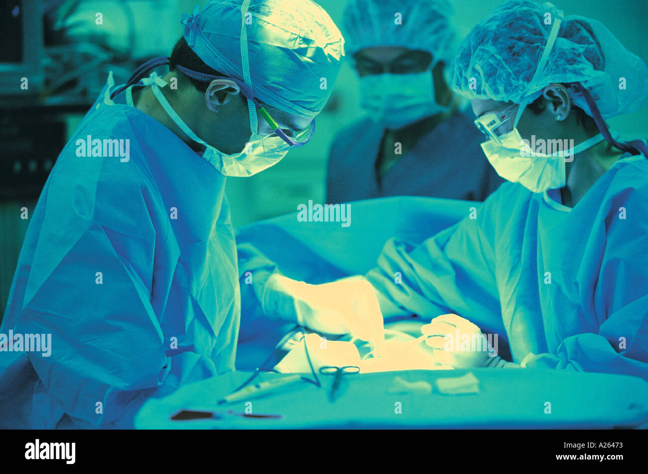 THREE SURGEONS PERFORMING A HERNIA OPERATION ON A CHILD Stock Photo - Alamy