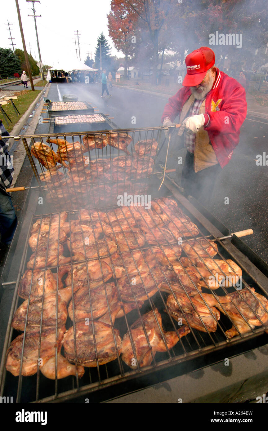 Chicken is prepared on large outdoor grill for autumn festival in ...