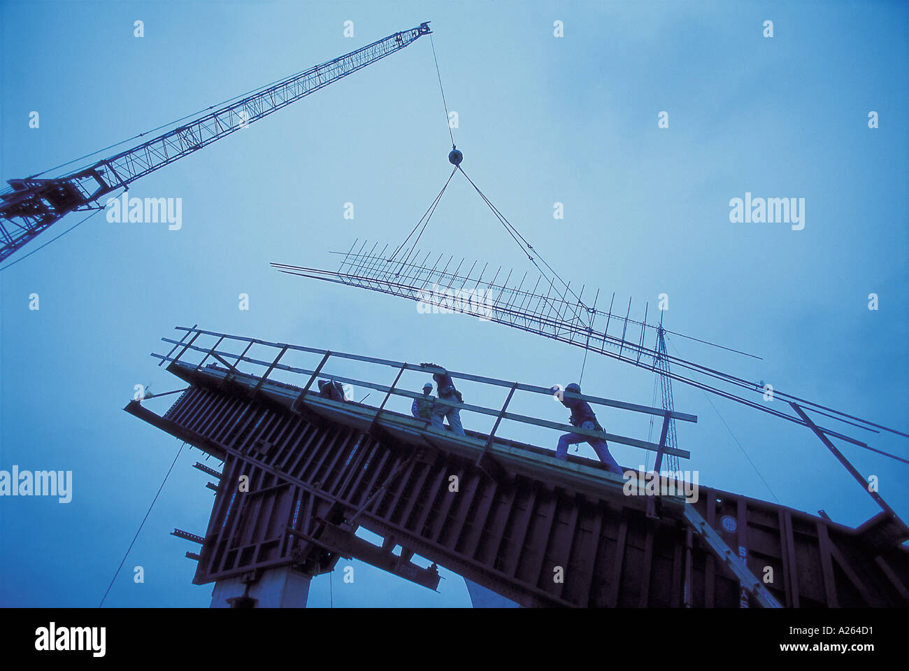 CONSTRUCTION WORKERS ON RAISED WALKWAY WITH CRANE Stock Photo - Alamy