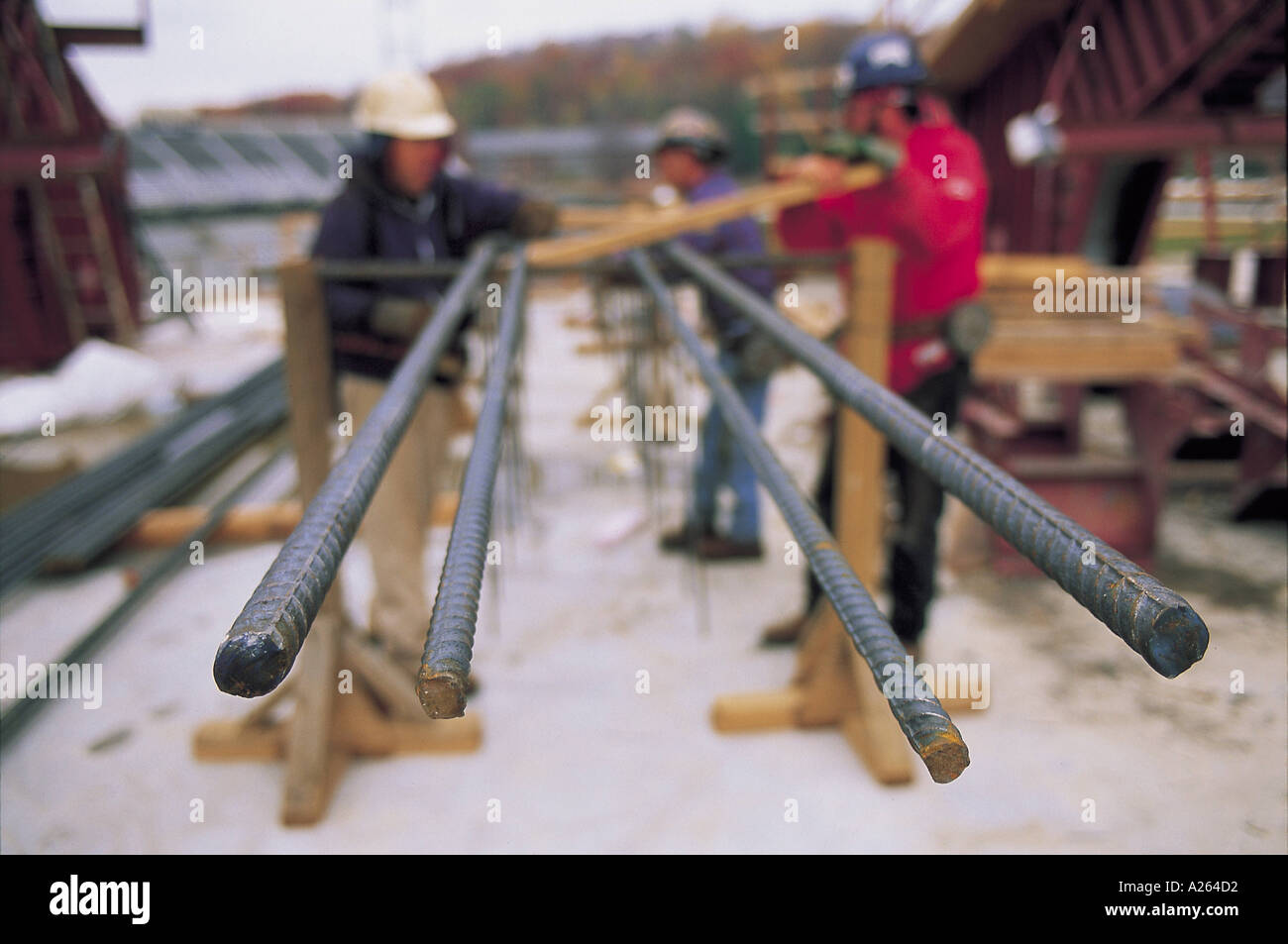 CONSTRUCTION SITE WITH WORKMEN HANDLING LONG METAL POLES Stock Photo ...
