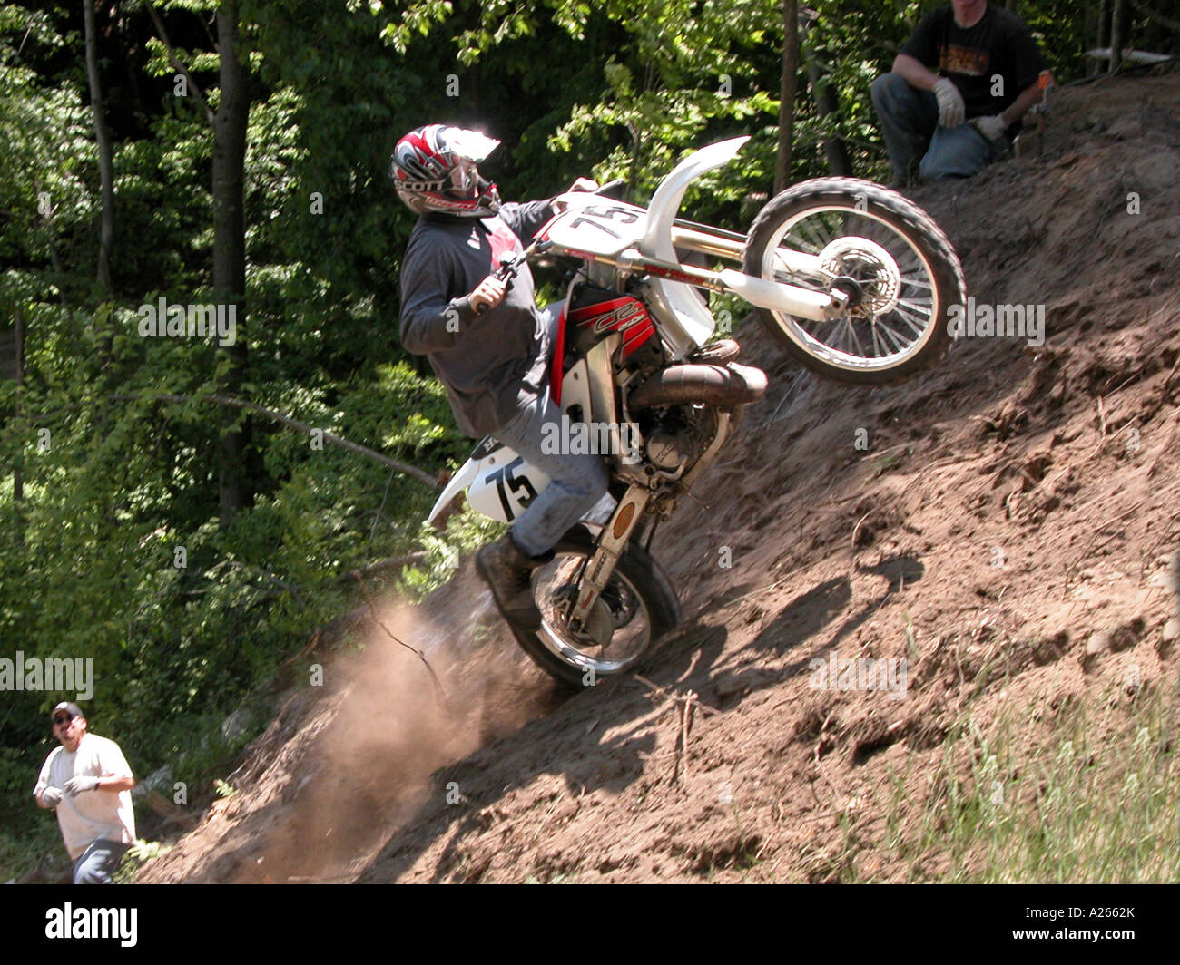 Contestants of all ages compete in a motorcycle hill climb race Stock ...