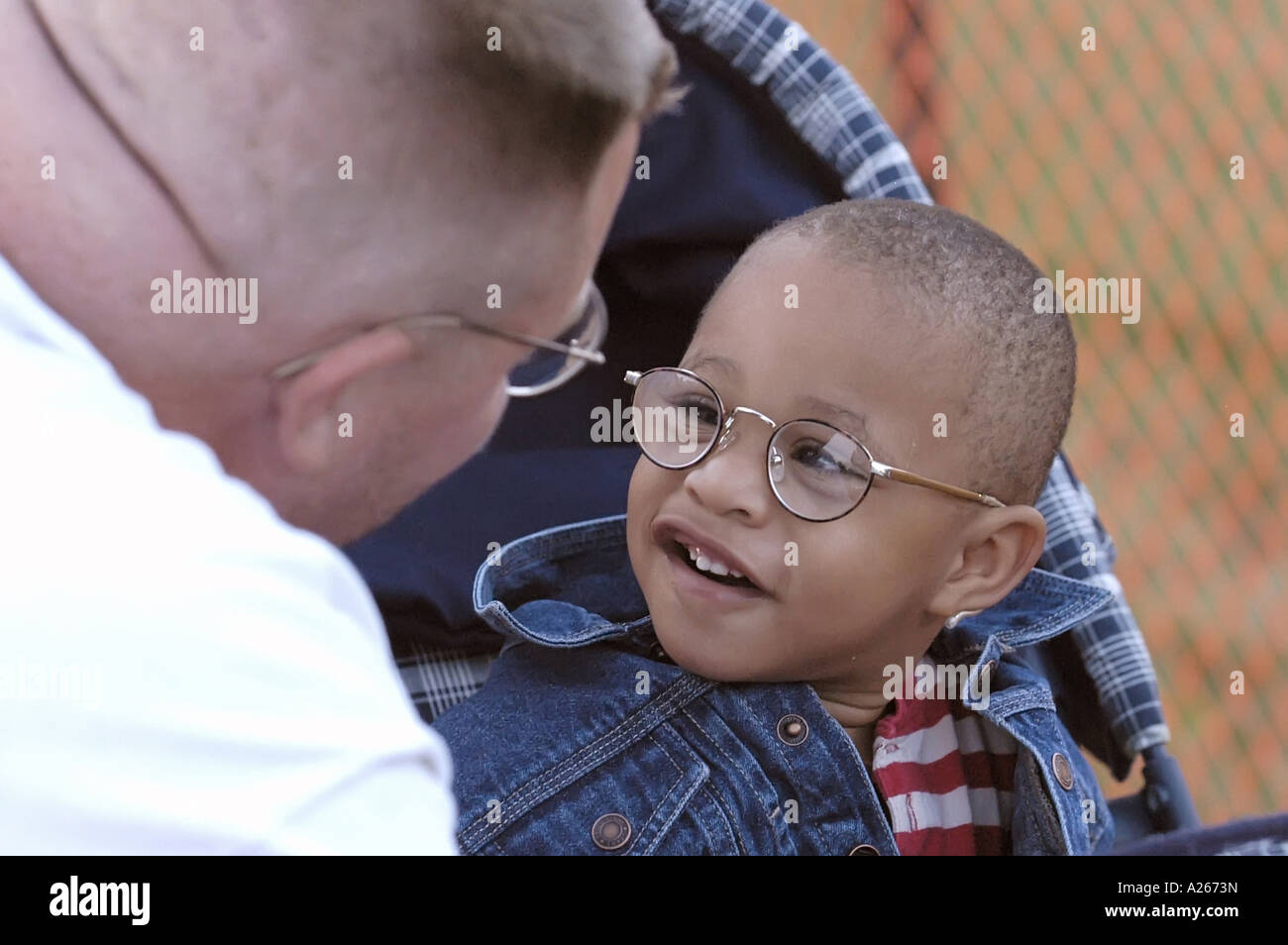 White father with adopted back son Stock Photo - Alamy