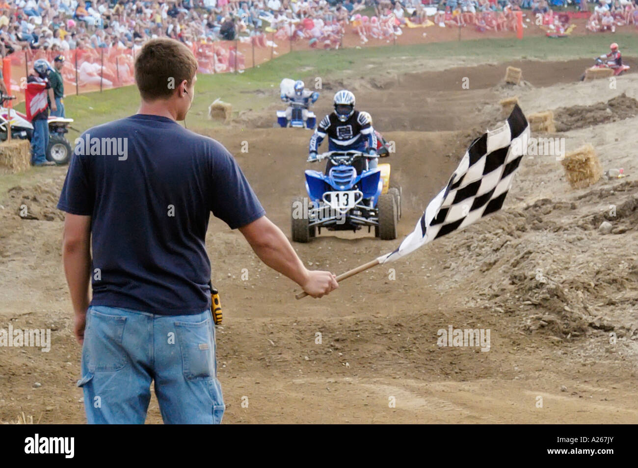 Contestant takes the checkered flag at the finish line in a off road ...