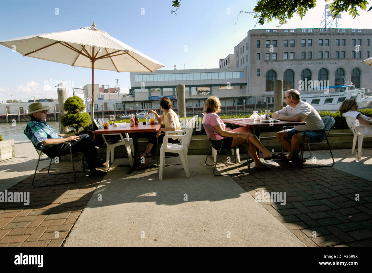 Adults dine outside on the patio of a restaurant Stock Photo - Alamy