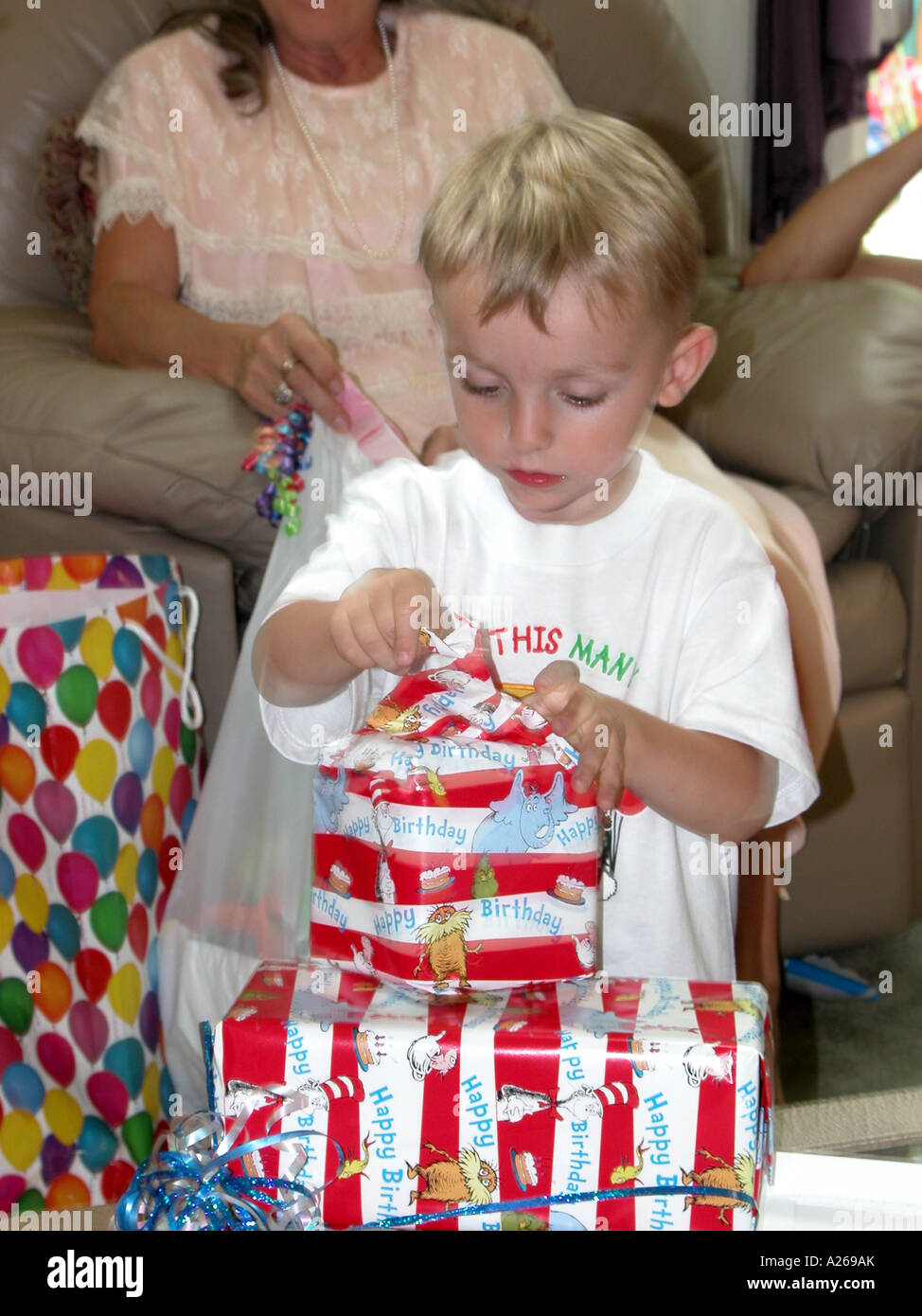 3 year old boy celebrates third birthday by having a party Stock Photo ...
