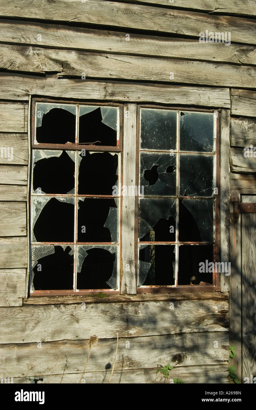 broken window panes on wood frame farm outbuilding Stock Photo - Alamy