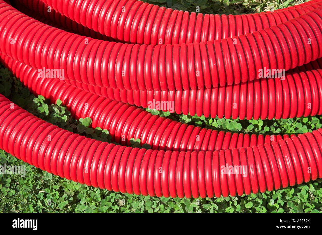 Red pipes on grass Stock Photo - Alamy
