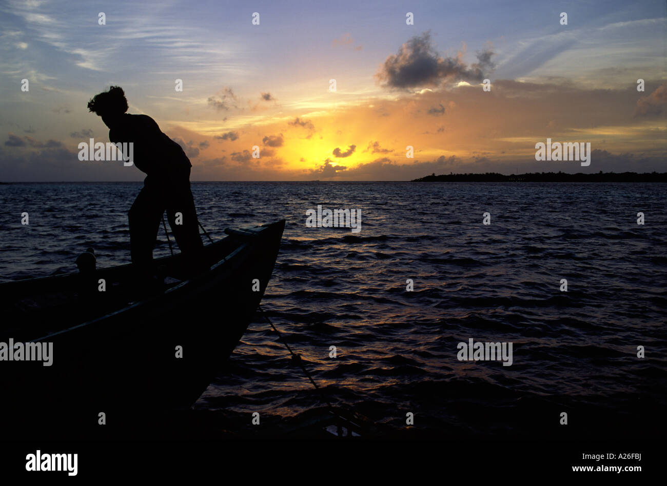 Maldives fisherman pulling up anchor Stock Photo - Alamy