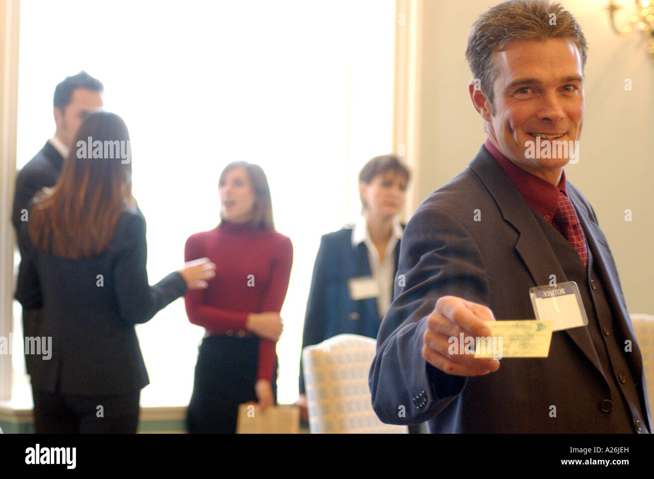 Salesman in business meeting with business card Stock Photo - Alamy