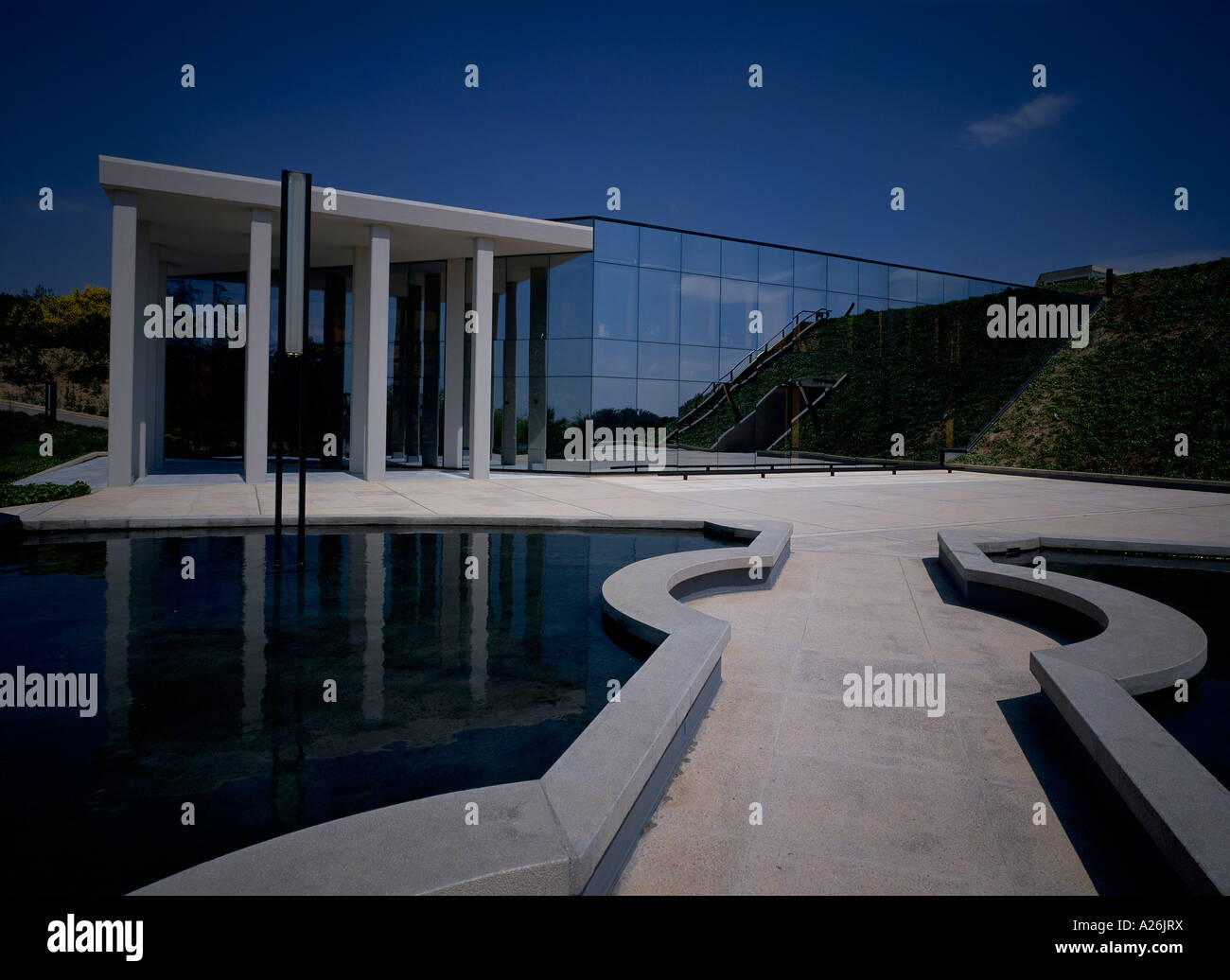 Water feature is seen near a glass building Stock Photo - Alamy