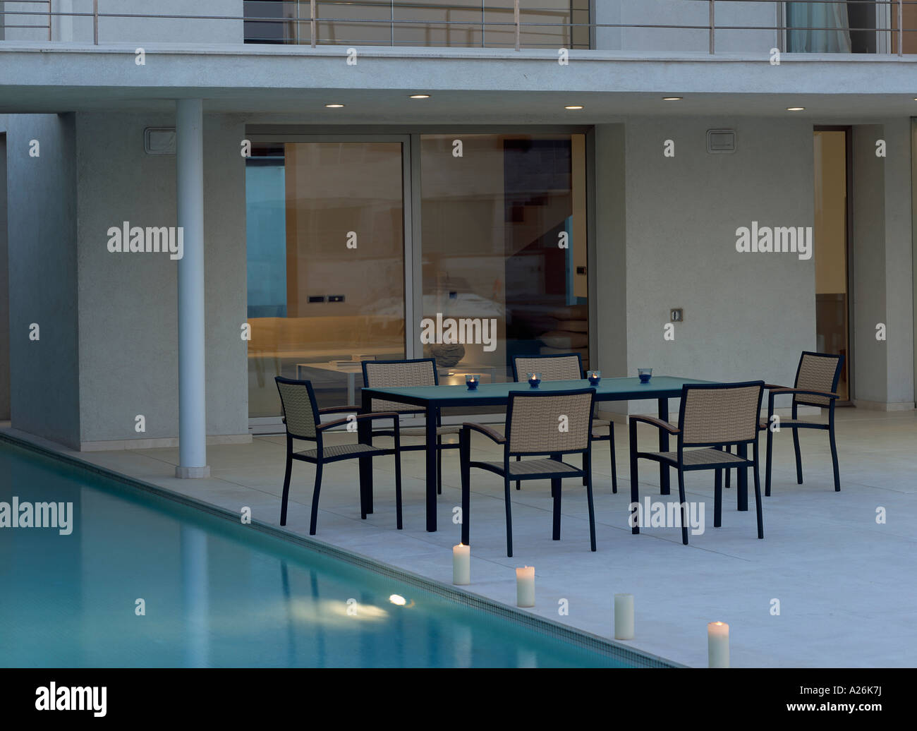 View of a dining table placed near a swimming pool Stock Photo - Alamy