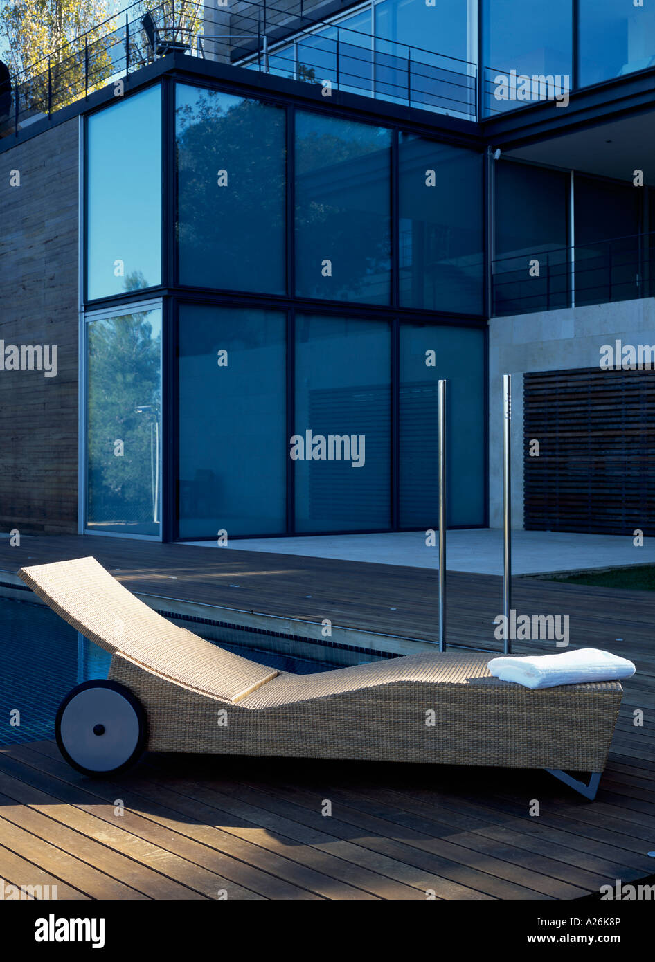 Reclining chair near a swimming pool hi-res stock photography and ...