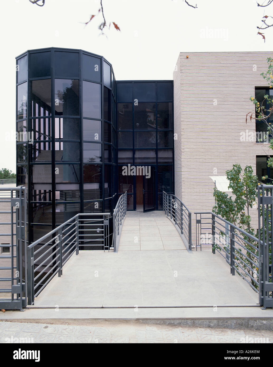 View of a bridge leading to an eclectic office building Stock Photo - Alamy