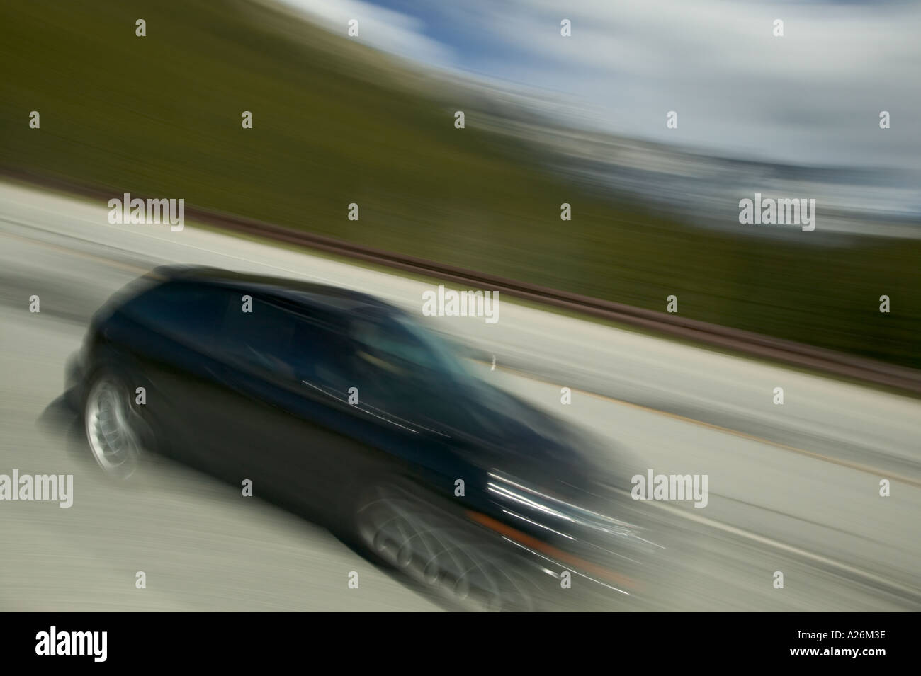 Car Speeding Down Mountain Road Stock Photo - Alamy