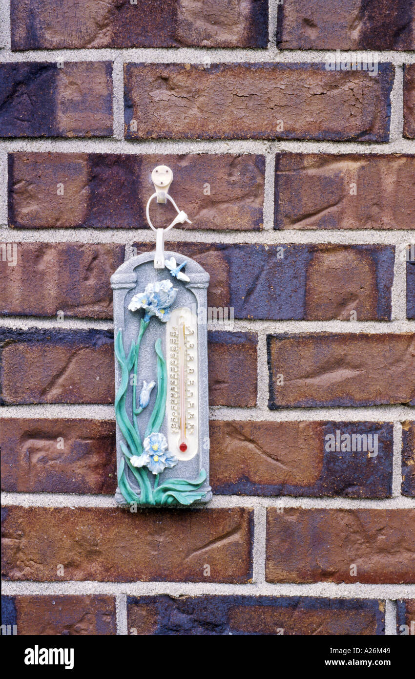 Outdoor thermometer hanging on a brick wall hi-res stock photography ...