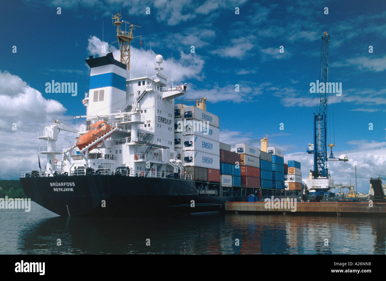 Container Ship Loading in a Harbour Stock Photo - Alamy