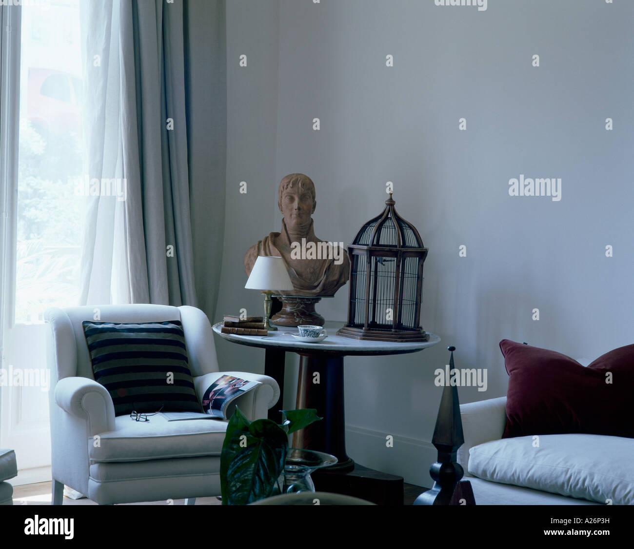 View of a bust and a cage kept on a table Stock Photo - Alamy