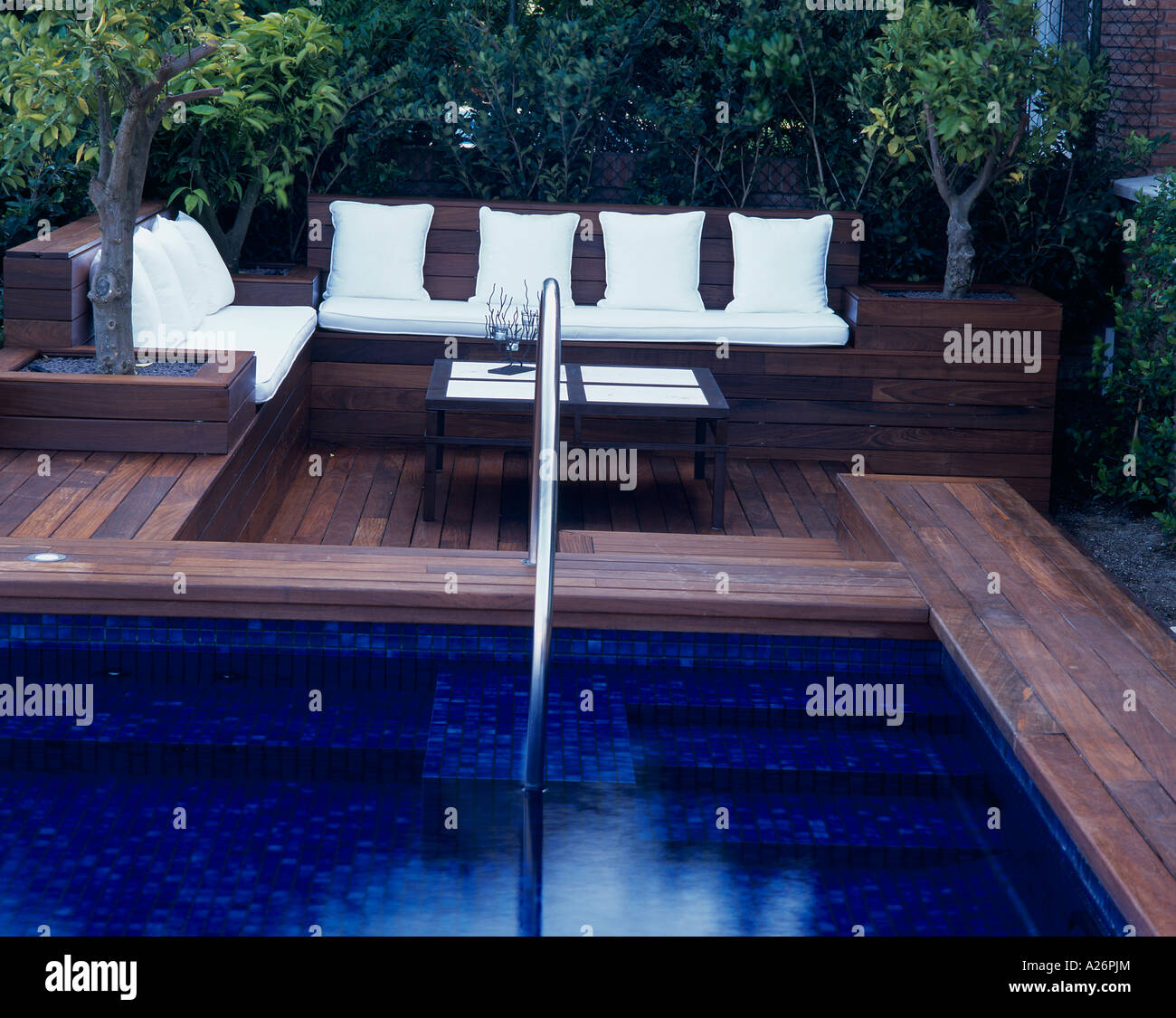 View of a seating arrangement against a swimming pool Stock Photo - Alamy