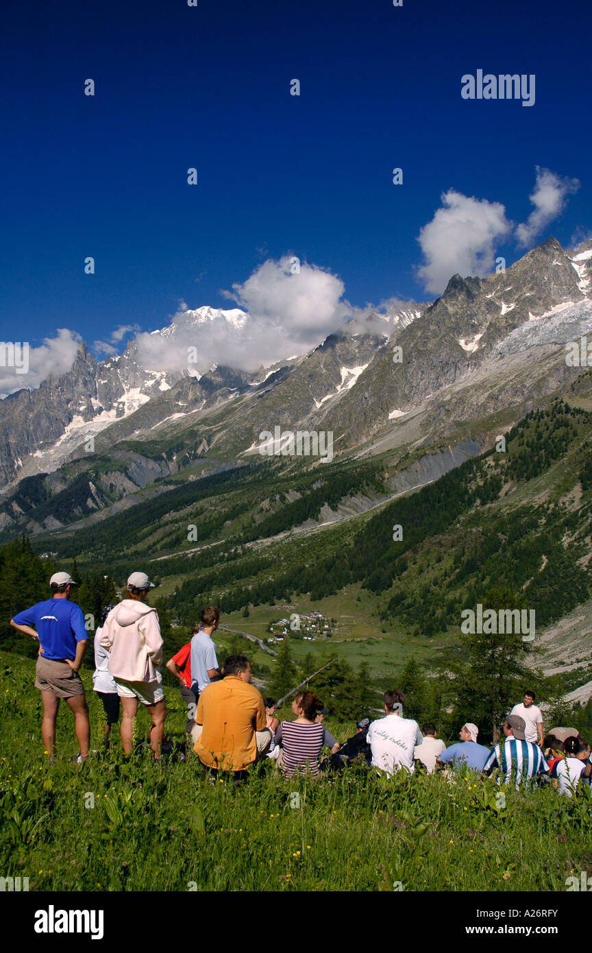 Group of hikers in Ferret Valley looking at the view of Mont Blanc ...