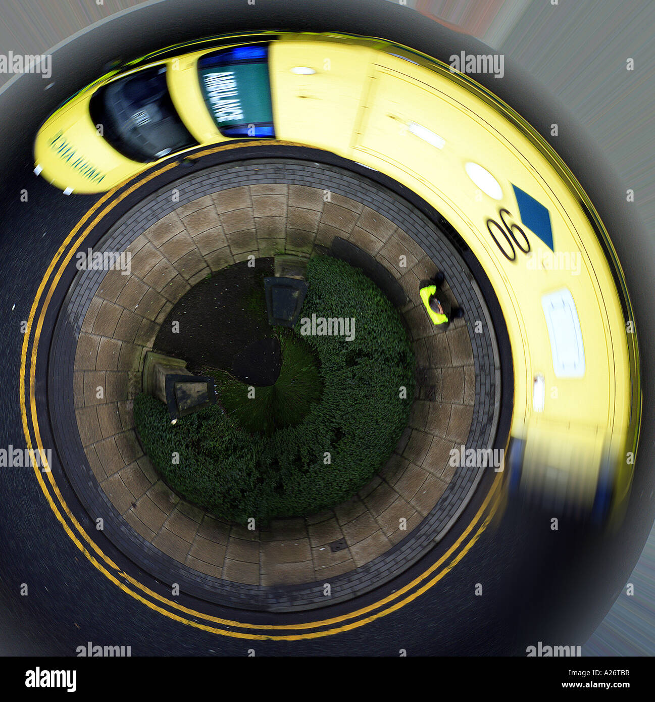 Aerial view of ambulance bending around a roundabout with speed and ...