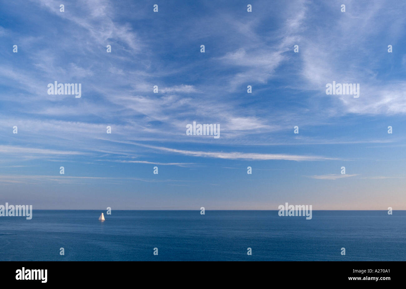 Yacht sailing in open sea against a big blue sky Stock Photo - Alamy
