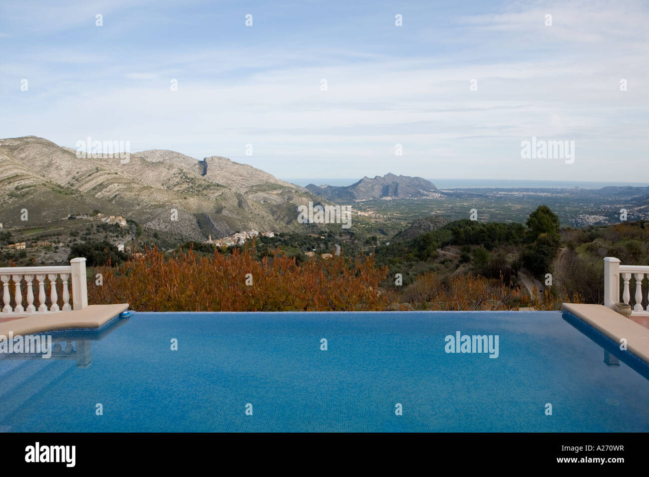 Balustrade edging infinity pool with mountains in background Stock ...