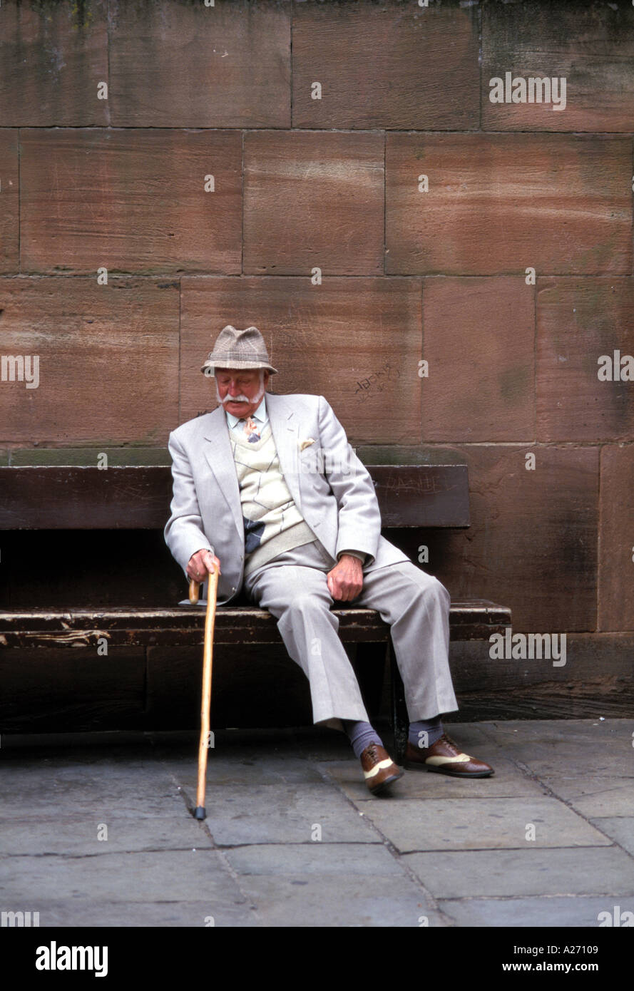Old man resting on bench in Chester UK Stock Photo - Alamy