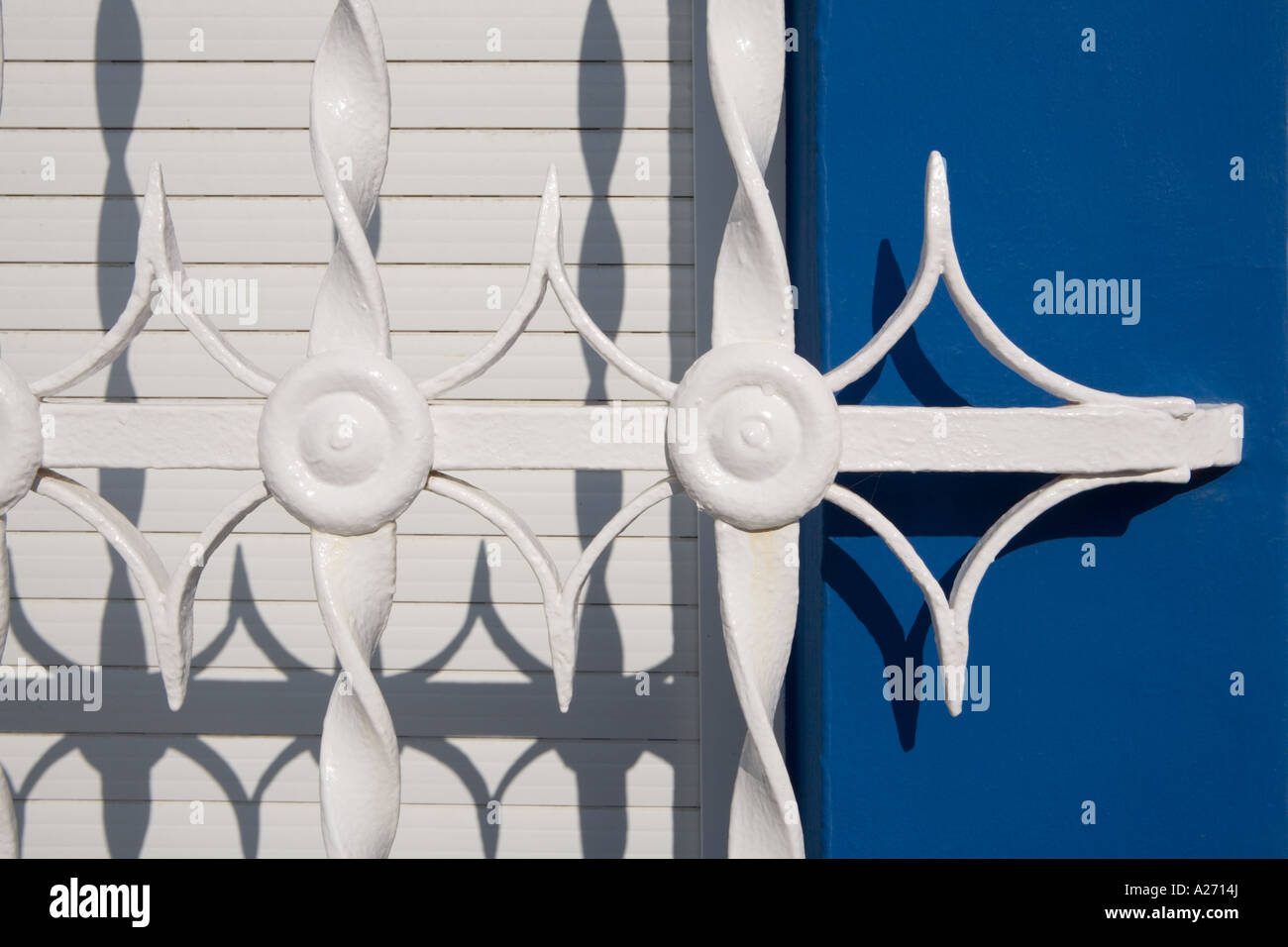 Decorative iron window bar detail and shadow forming abstract pattern ...