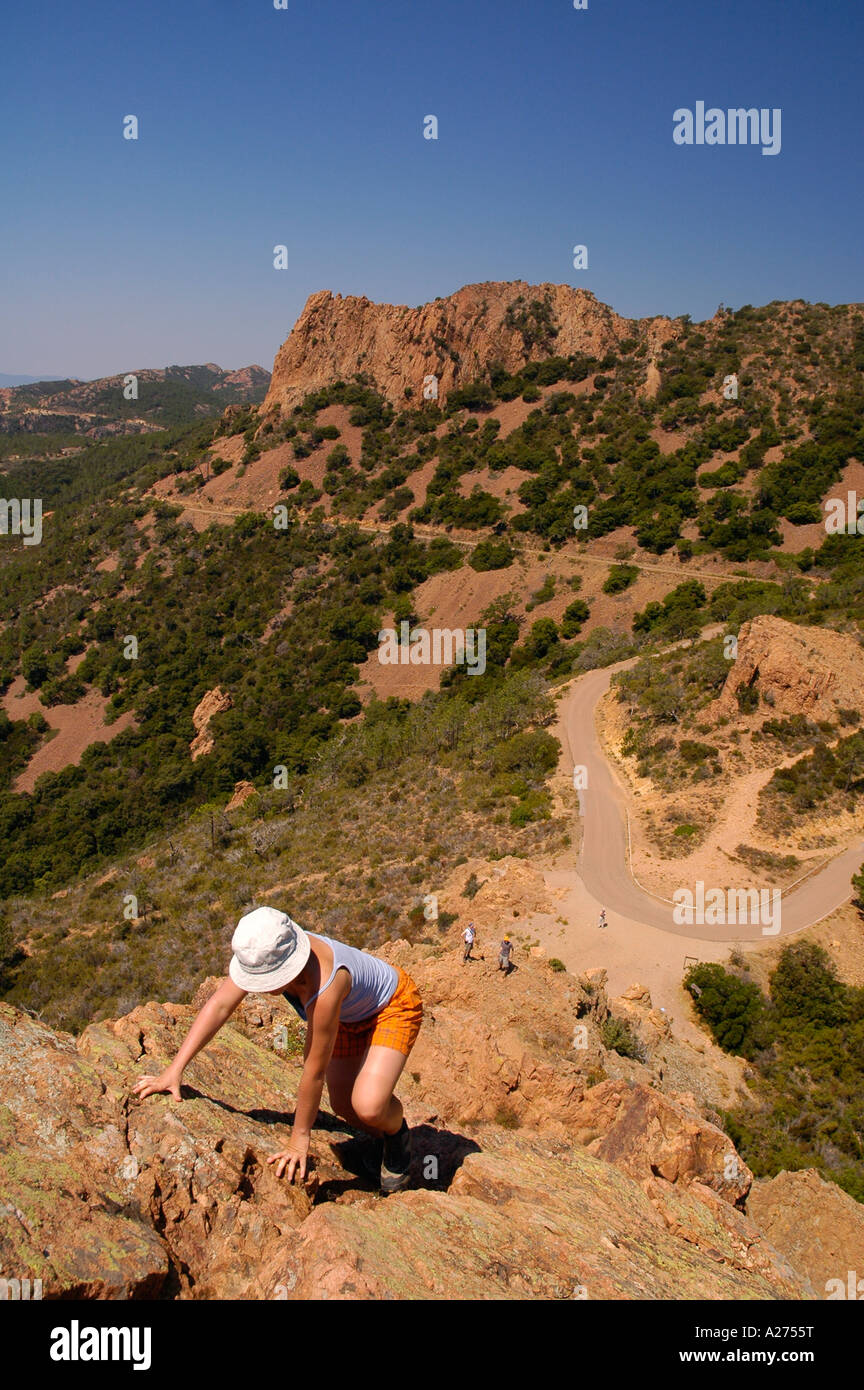 Climber ascending rocky formation in Massif de l'Esterel, Cote d'Azur ...
